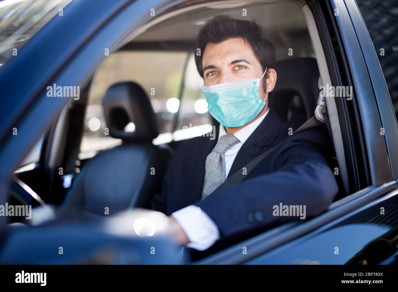 Masked man driving his car during coronavirus pandemic Stock Photo - Alamy