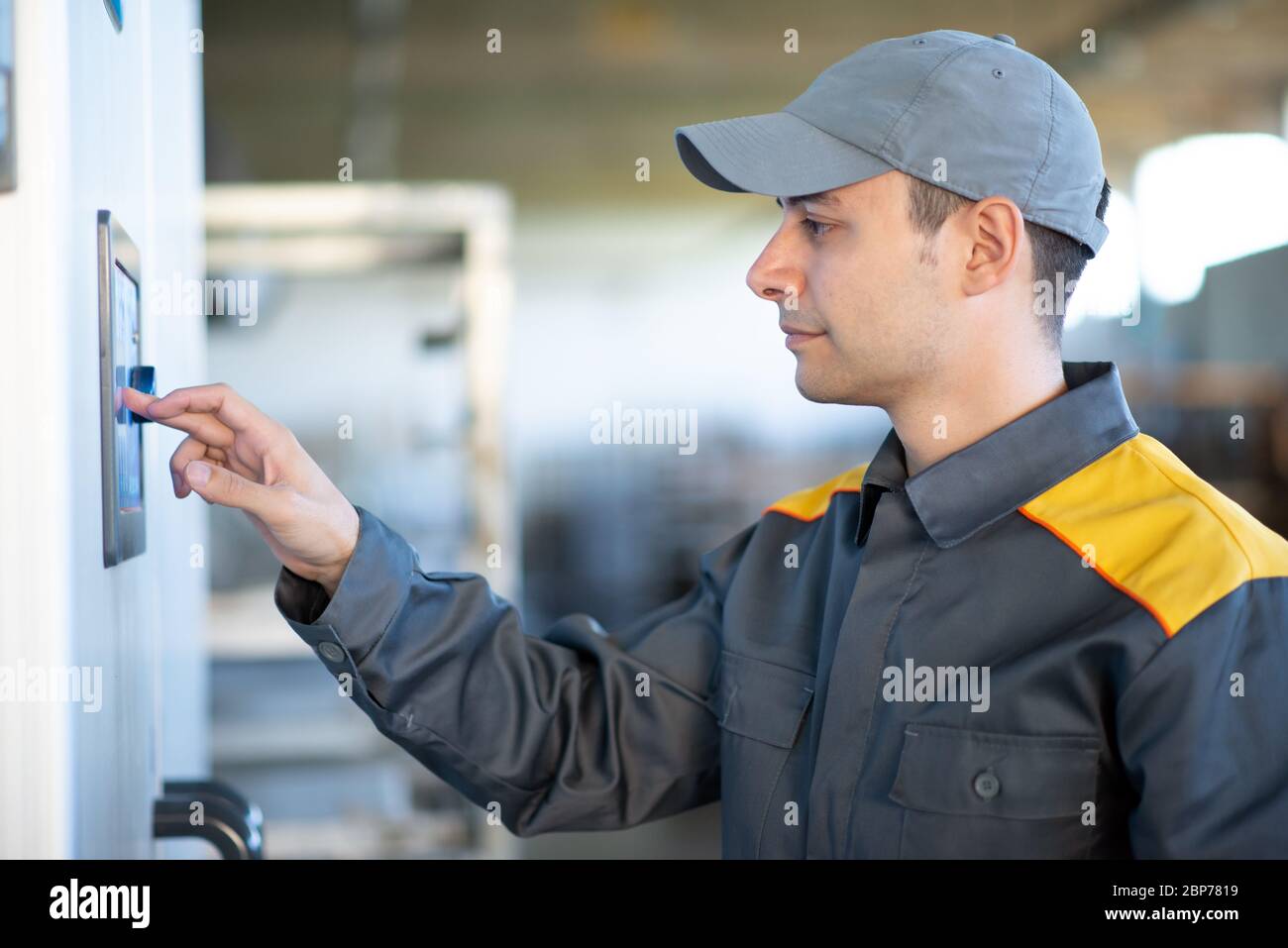 Worker using a touchscreen in an industrial factory Stock Photo - Alamy