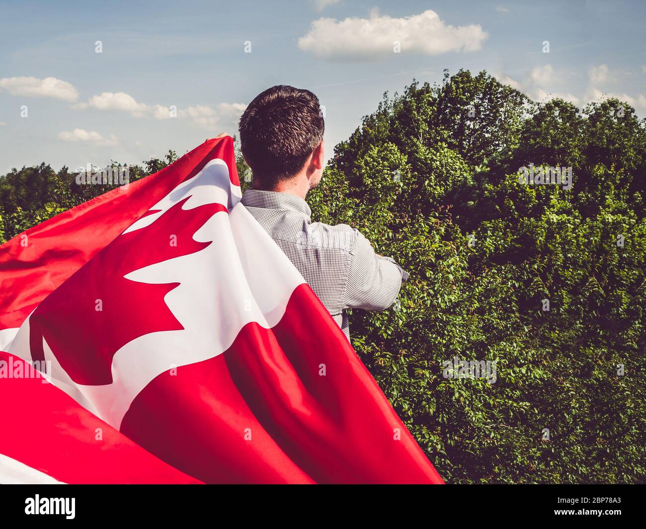 Attractive man holding Canadian Flag. National holiday Stock Photo - Alamy