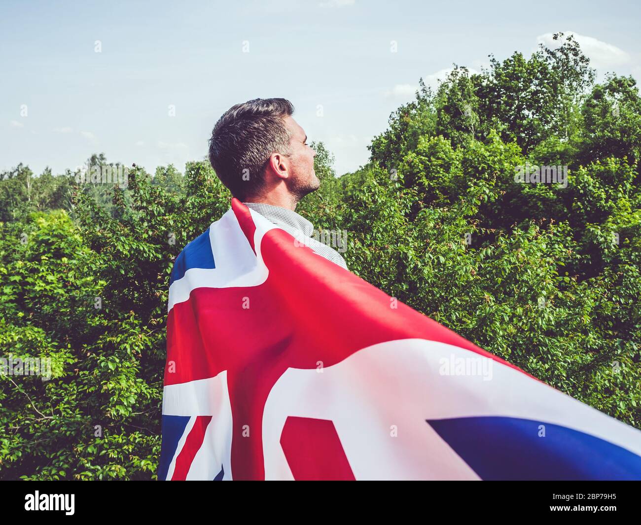 Uk flag waving blue sky hands hi-res stock photography and images - Alamy