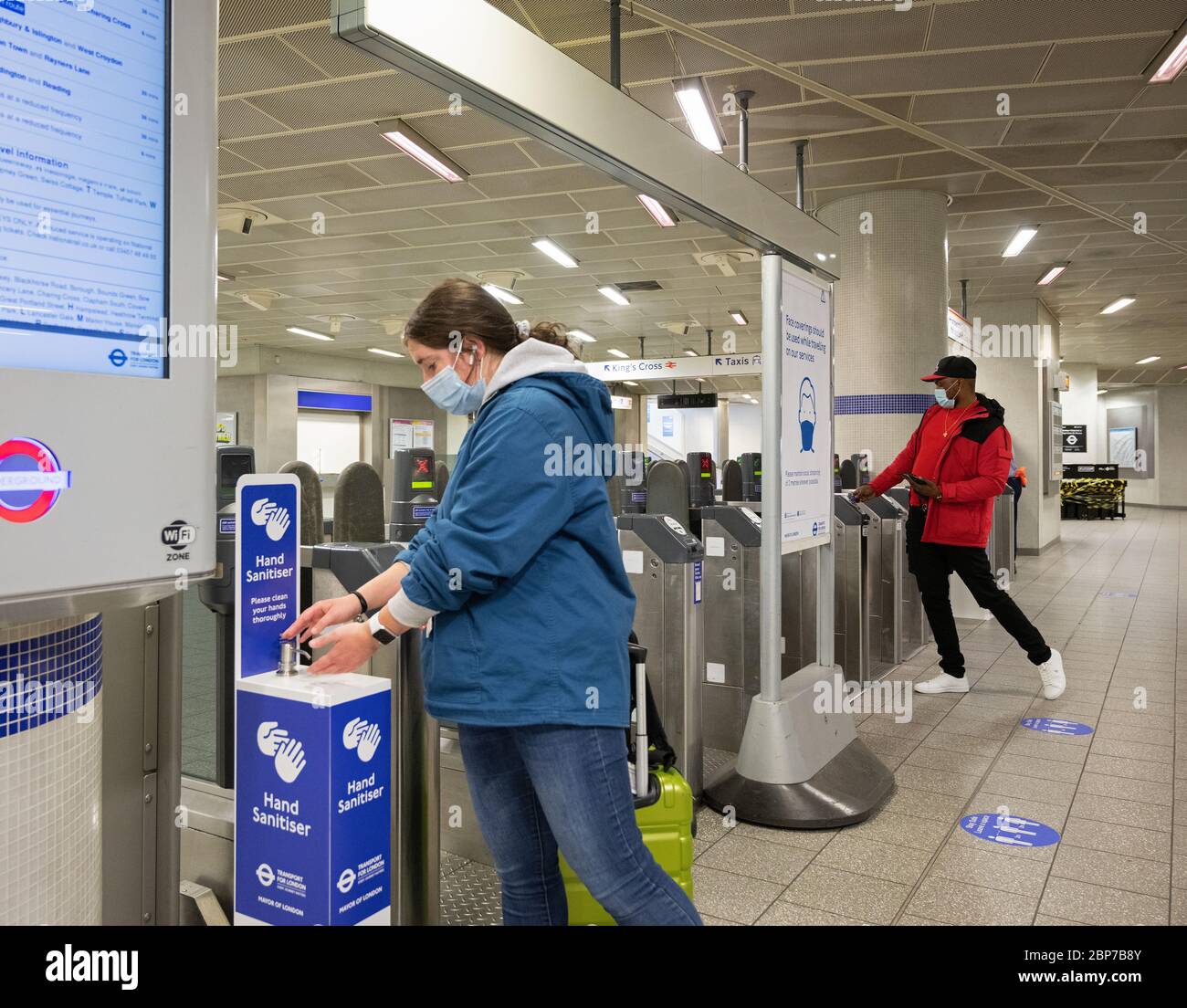Passengers use hand sanitiser points on the London Underground during ...