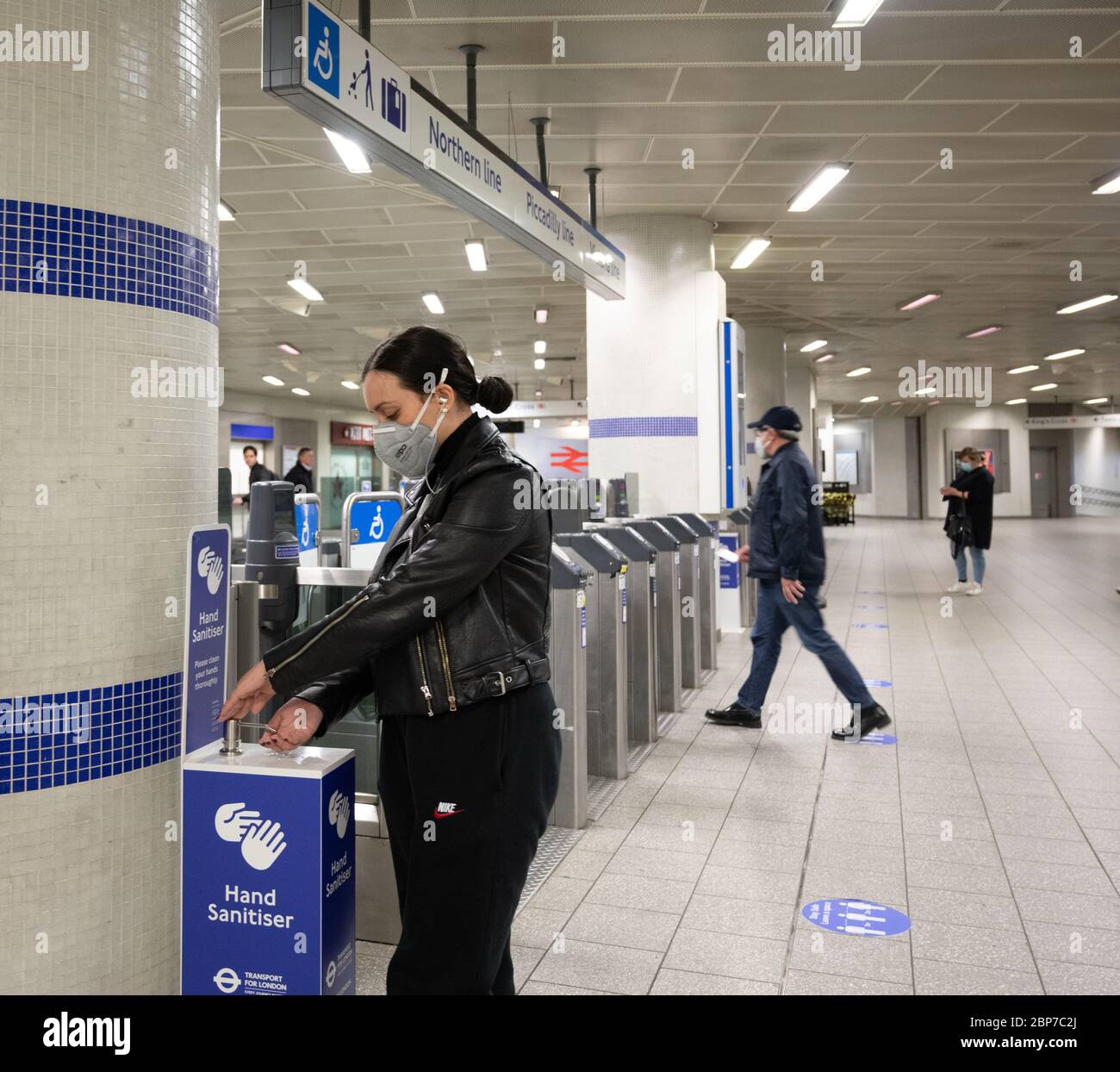 Passengers use hand sanitiser points on the London Underground during ...