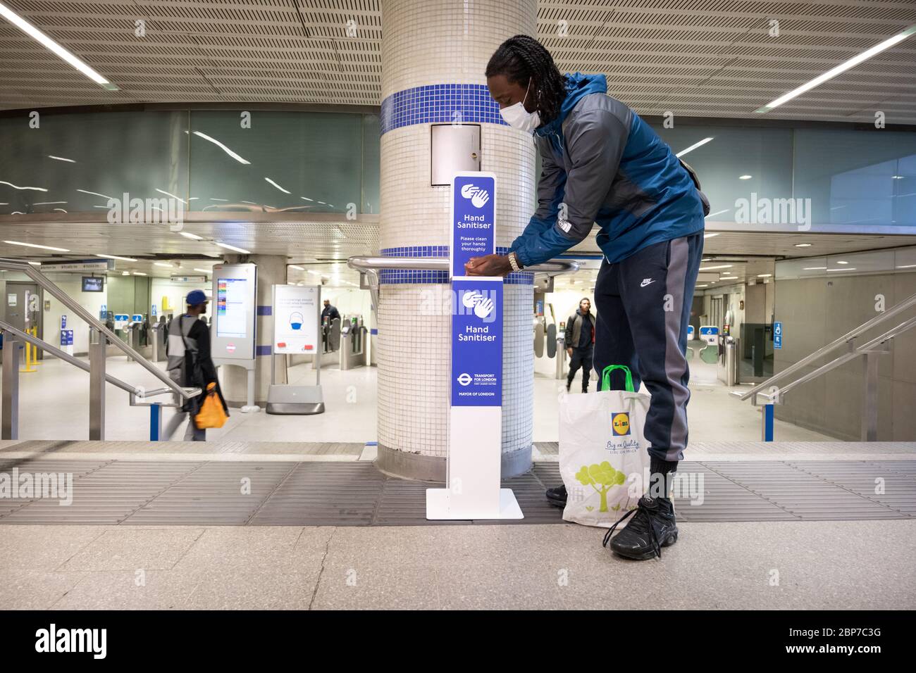 Passengers use hand sanitiser points on the London Underground during ...