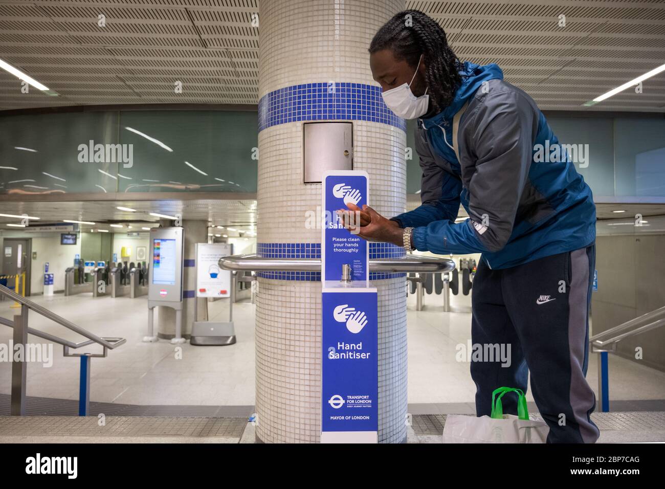 Passengers use hand sanitiser points on the London Underground during ...