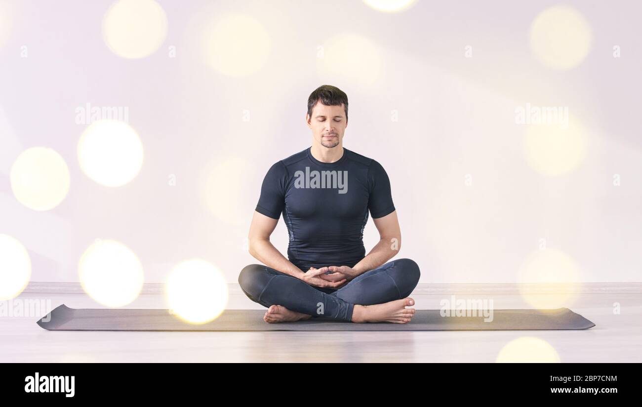Man sitting at lotus yoga pose. Home morning routine Stock Photo - Alamy