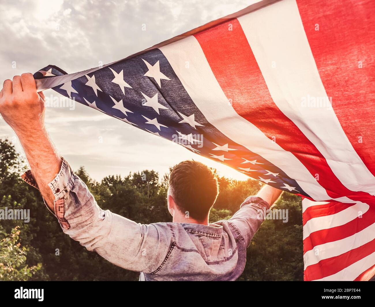 Attractive man holding Flag of the United States Stock Photo - Alamy