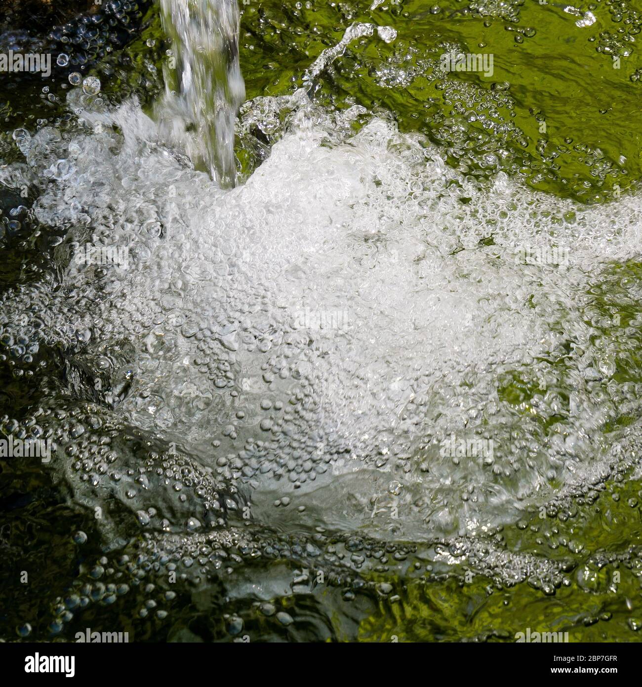 Water jet splashing in a public fountain, Cerin, Bugey Massif, Ain ...