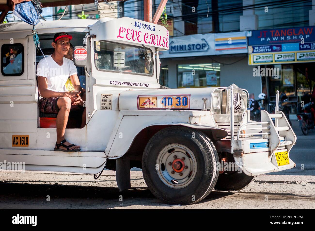 A classic jeepney pulls in at the main bus stop in Angeles City, Luzon ...
