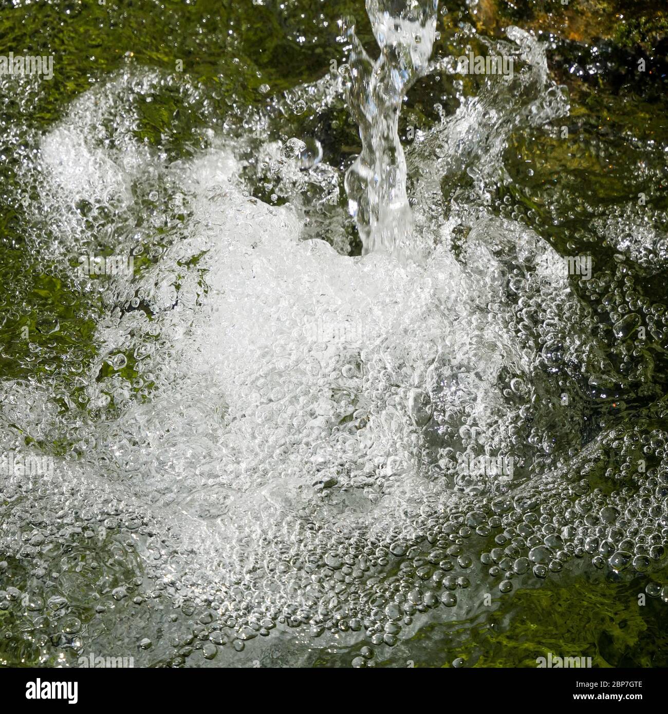 Water jet splashing in a public fountain, Cerin, Bugey Massif, Ain ...