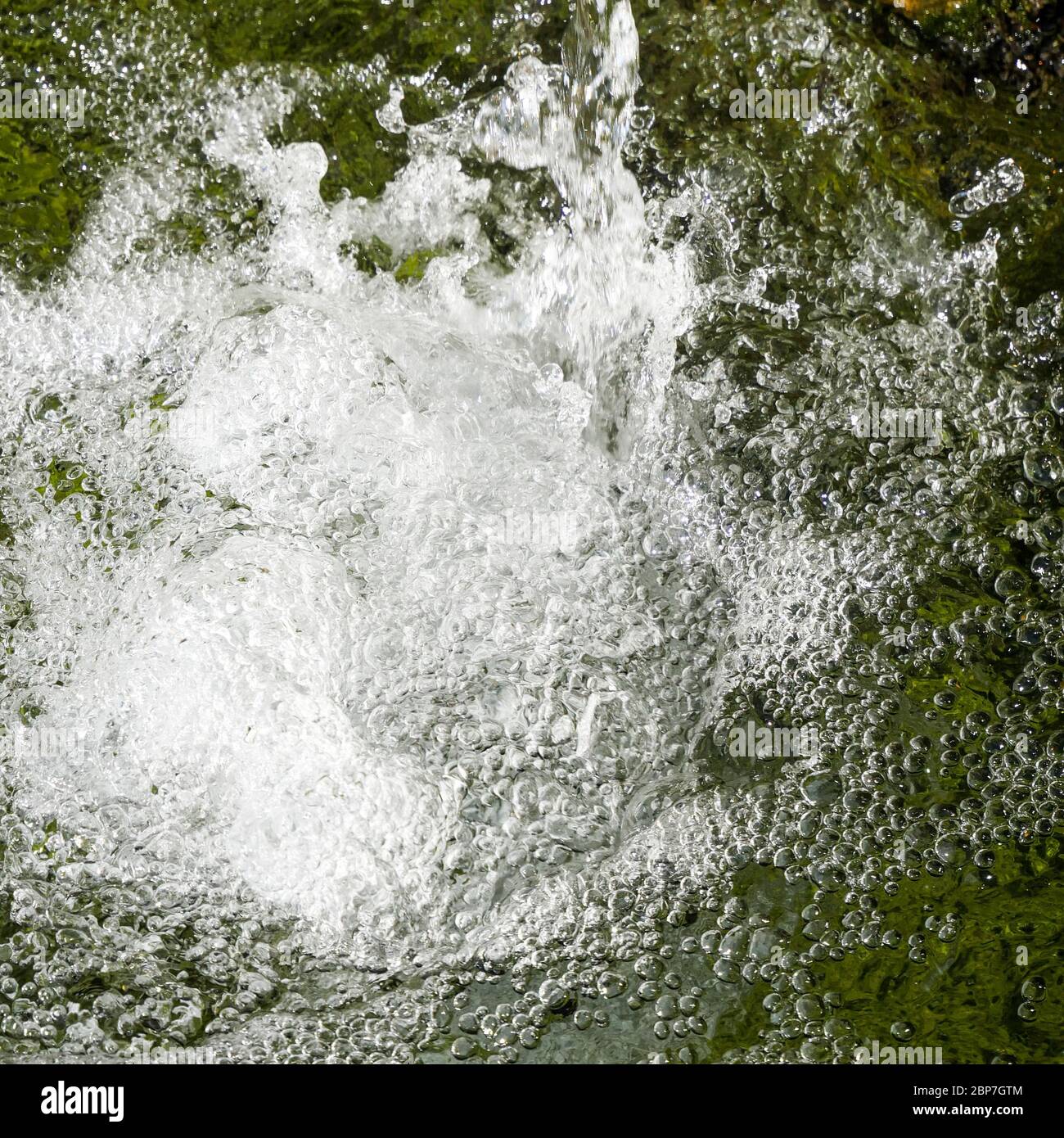 Water jet splashing in a public fountain, Cerin, Bugey Massif, Ain ...