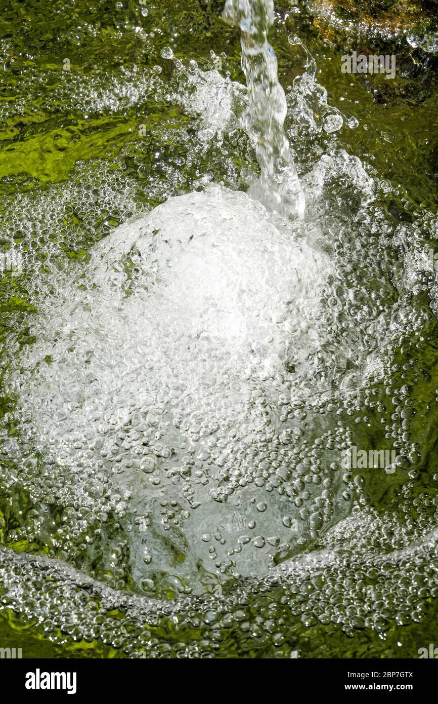 Water jet splashing in a public fountain, Cerin, Bugey Massif, Ain ...