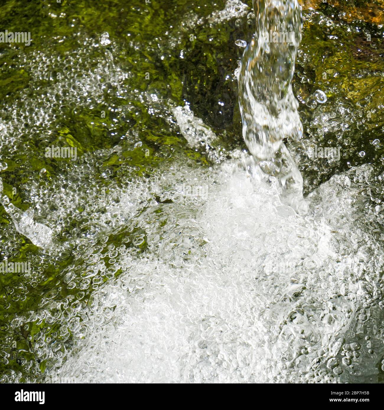 Water jet splashing in a public fountain, Cerin, Bugey Massif, Ain ...