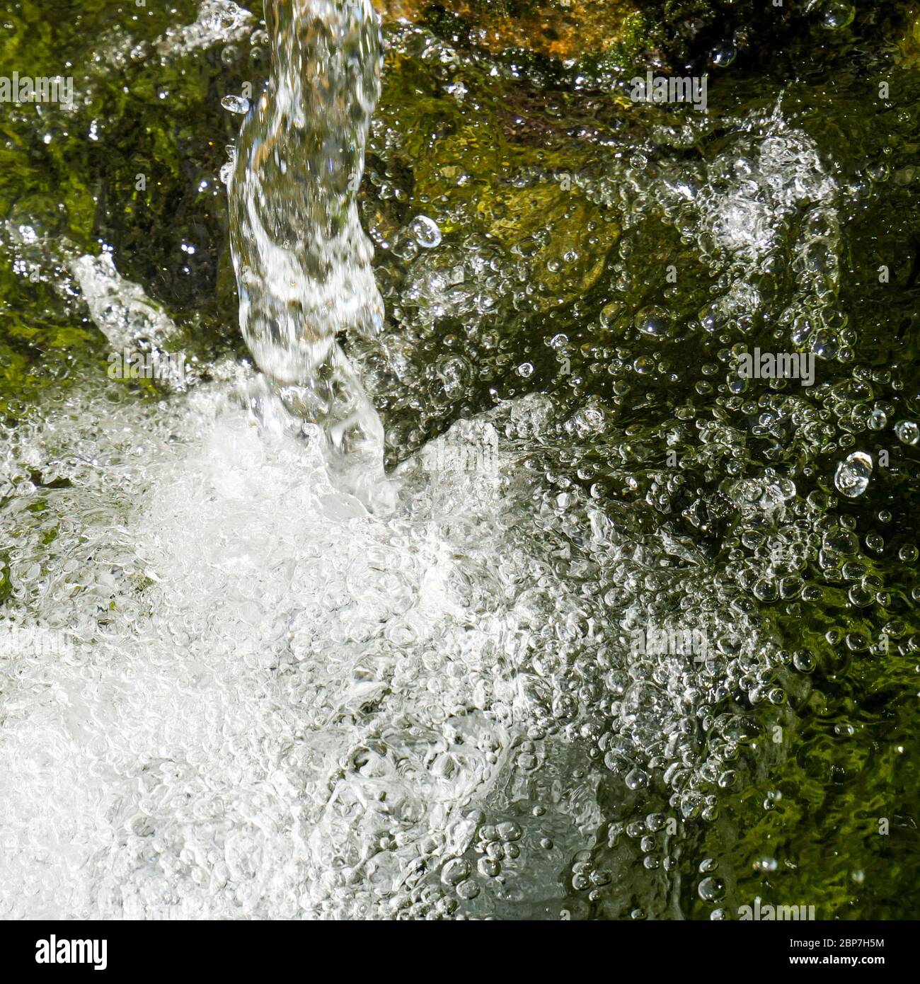 Water jet splashing in a public fountain, Cerin, Bugey Massif, Ain ...