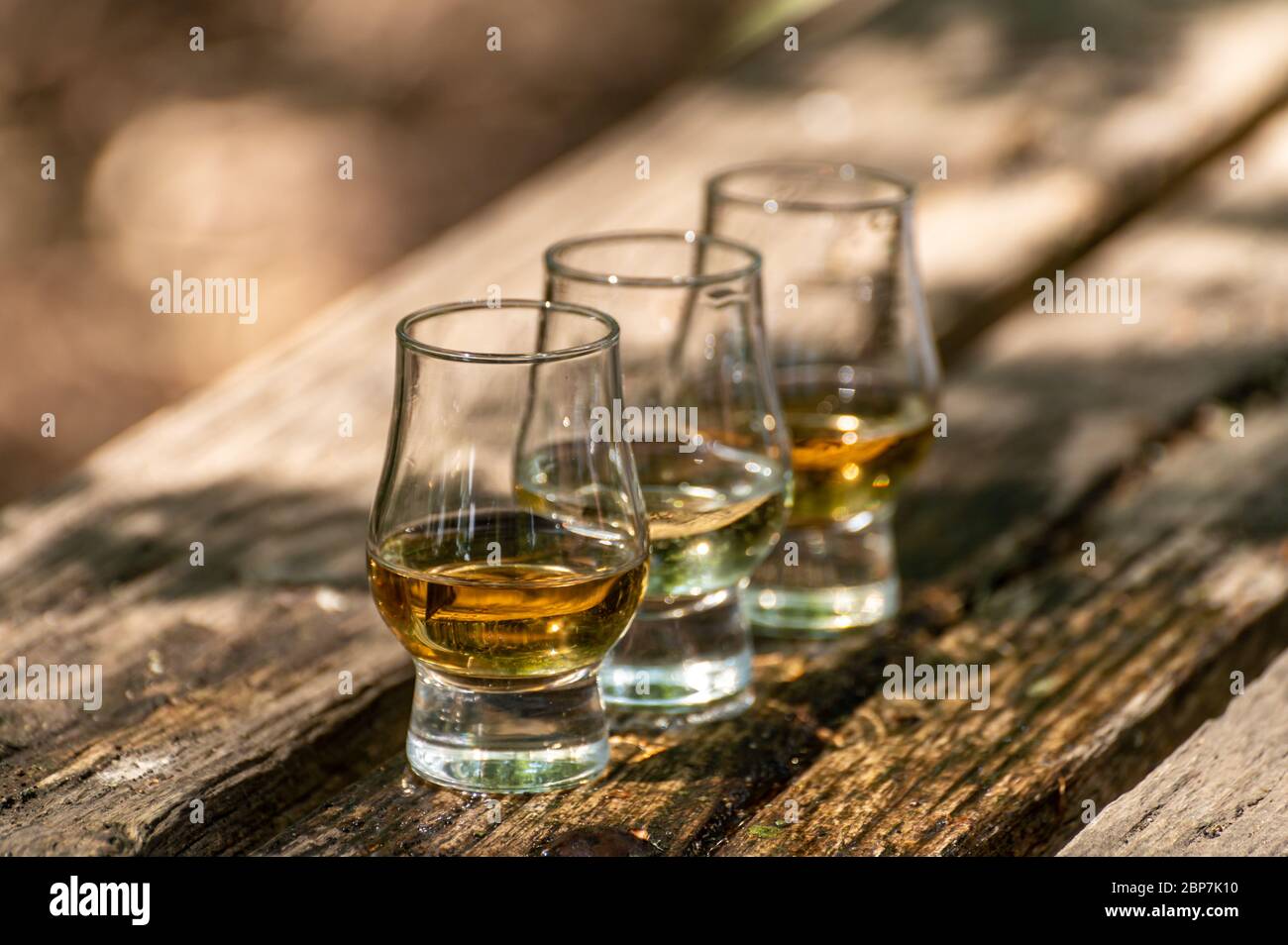 Tasting of different Scotch whiskies on outdoor terrace, dram of ...