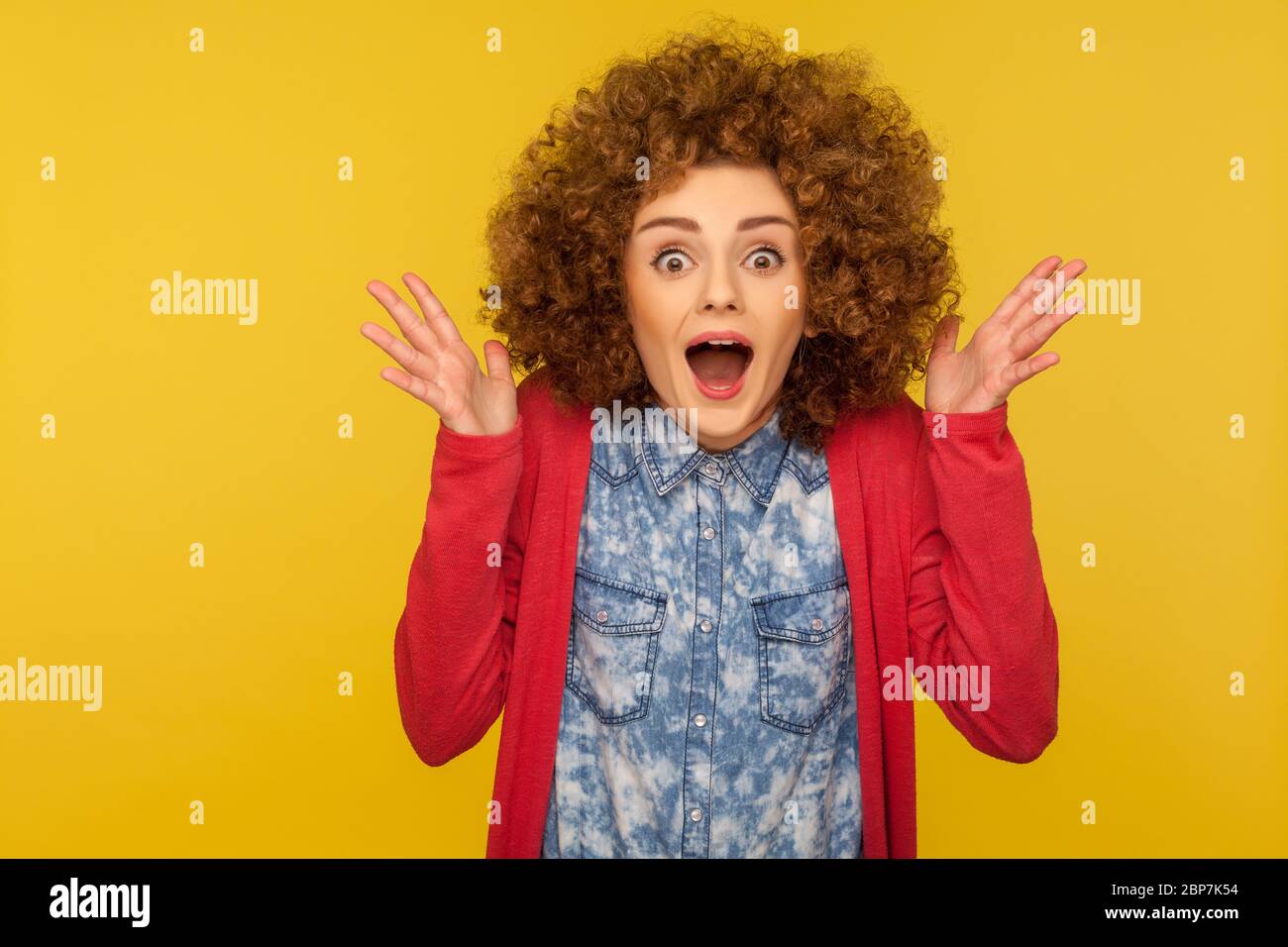 Wow, I'm impressed! Portrait of excited amazed woman with fluffy curly ...