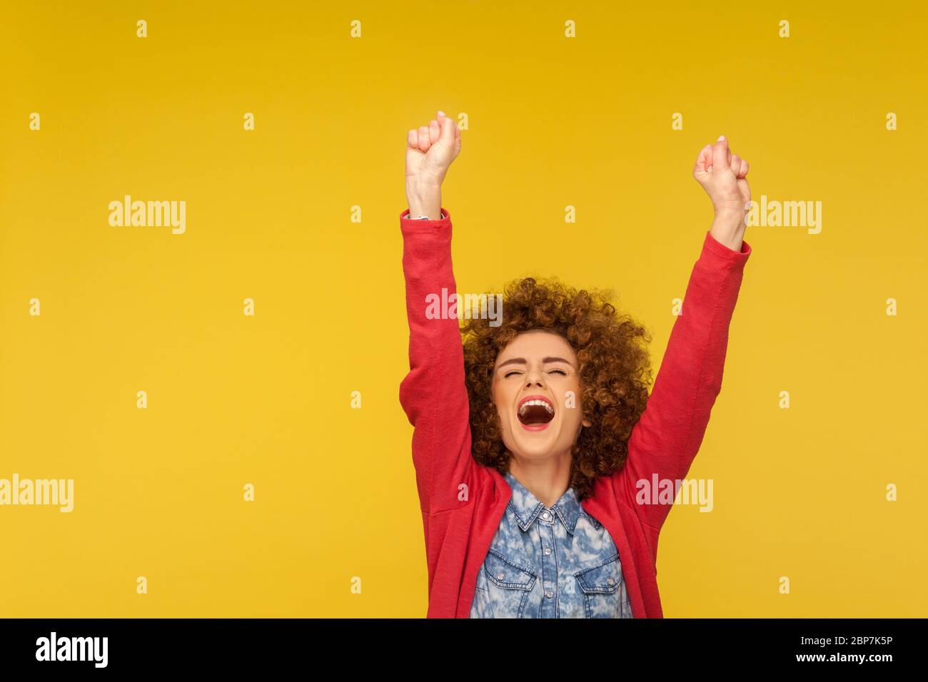 Hurray, I am champion! Portrait of ecstatic happy woman with curly hair ...