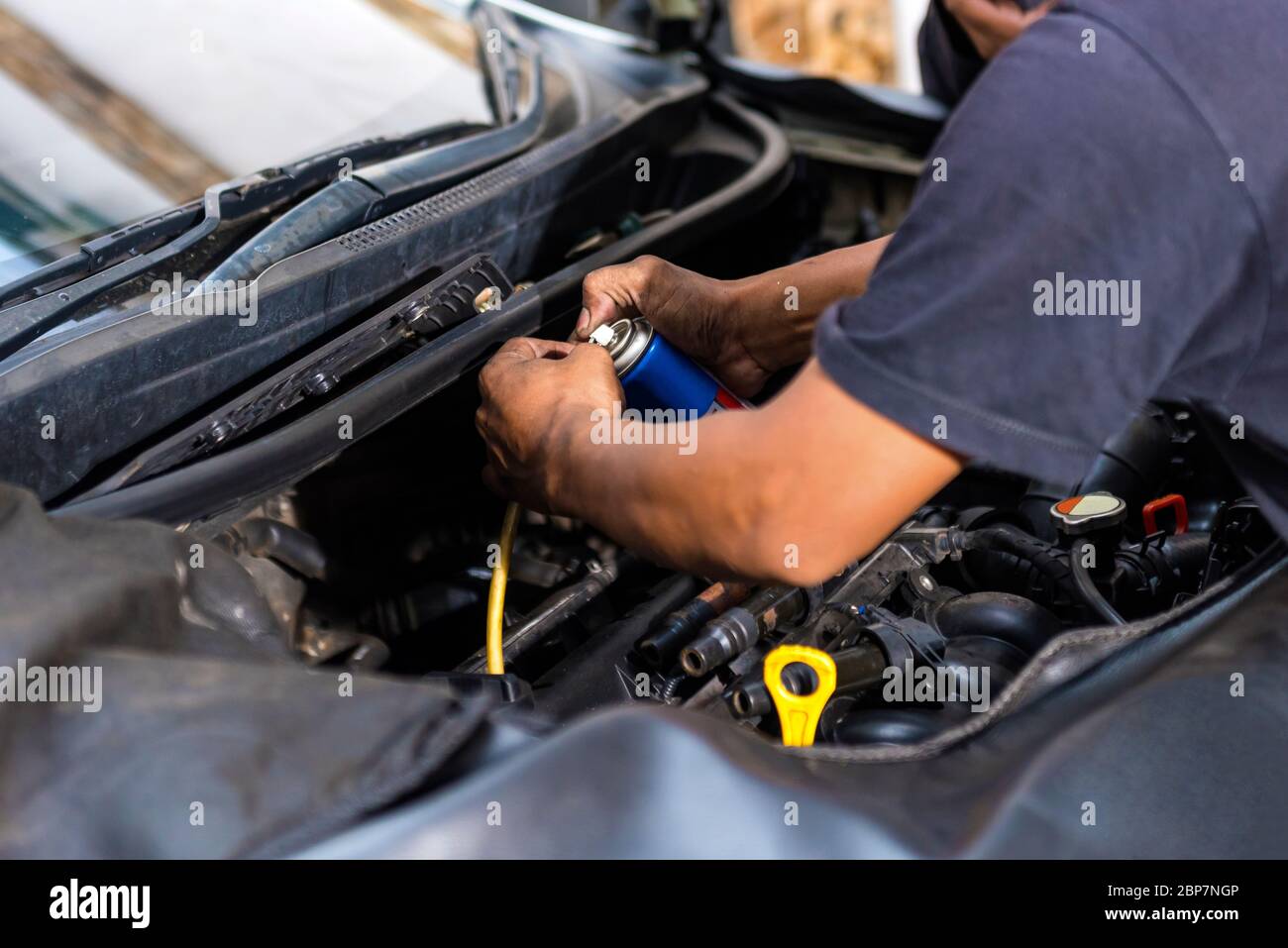 Car mechanic cleaning car engine with liquid on the garage Stock Photo ...