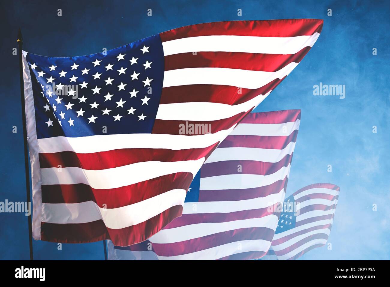 American flag waving in the air with a blue background. Fourth of July ...