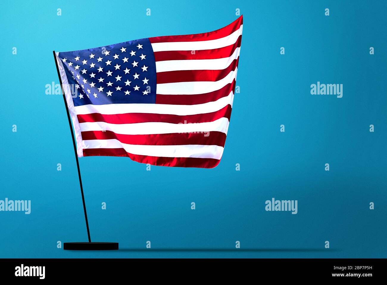American flag waving in the air with a blue background. Fourth of July ...