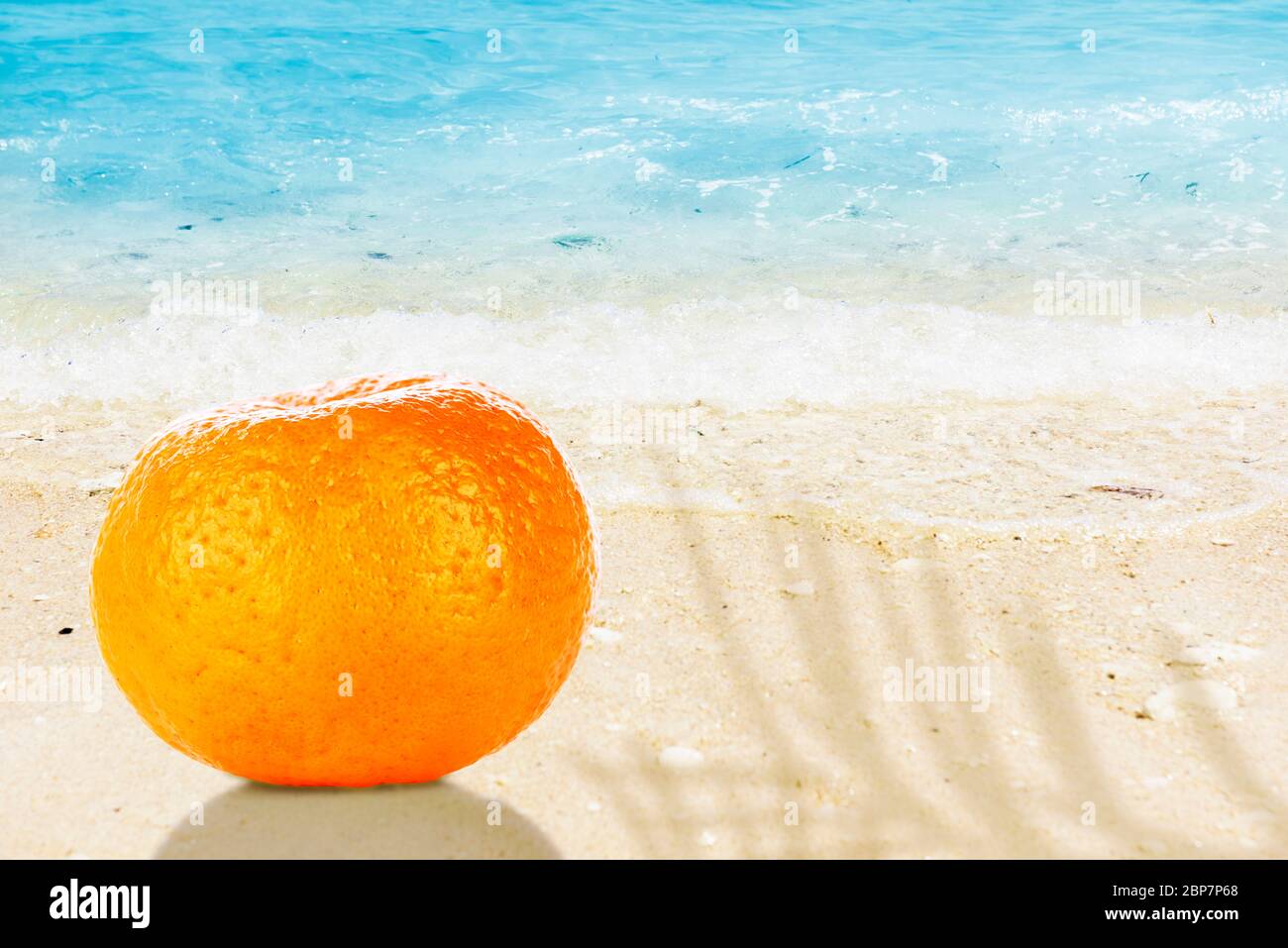 Oranges on the beach with ocean view background Stock Photo - Alamy