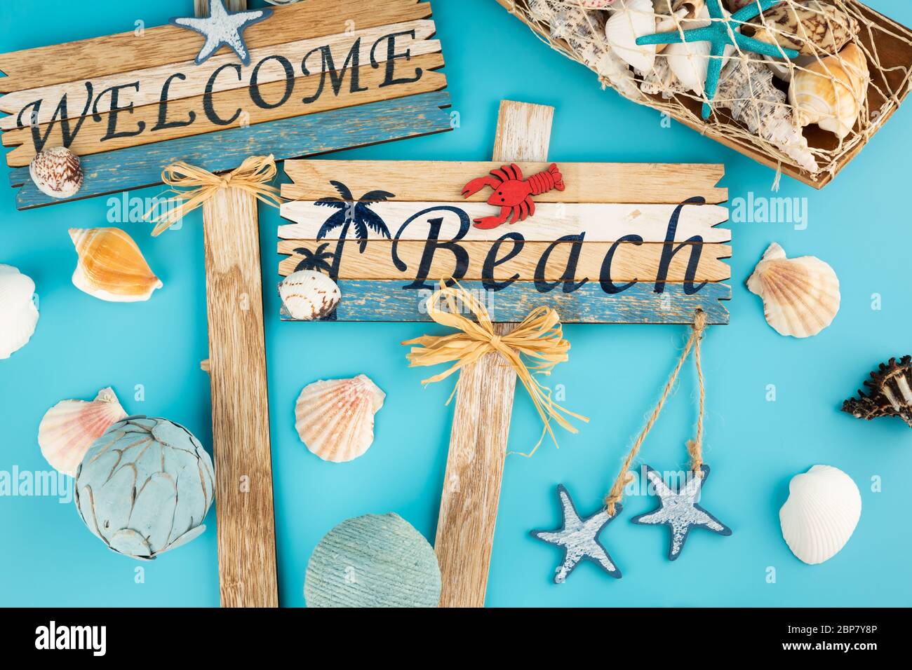 Wooden signs welcome beach and shells on blue background Stock Photo ...