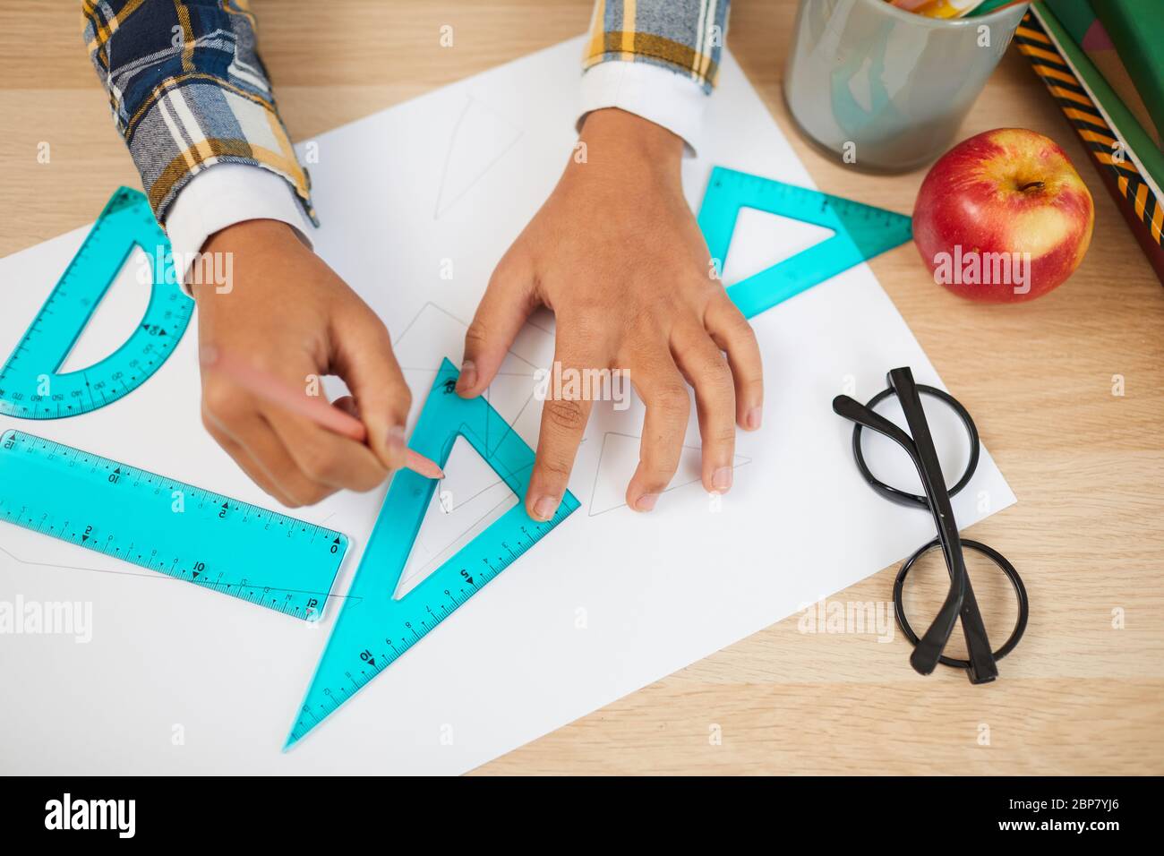 Close up of unrecognizable African-American boy drawing geometrical ...