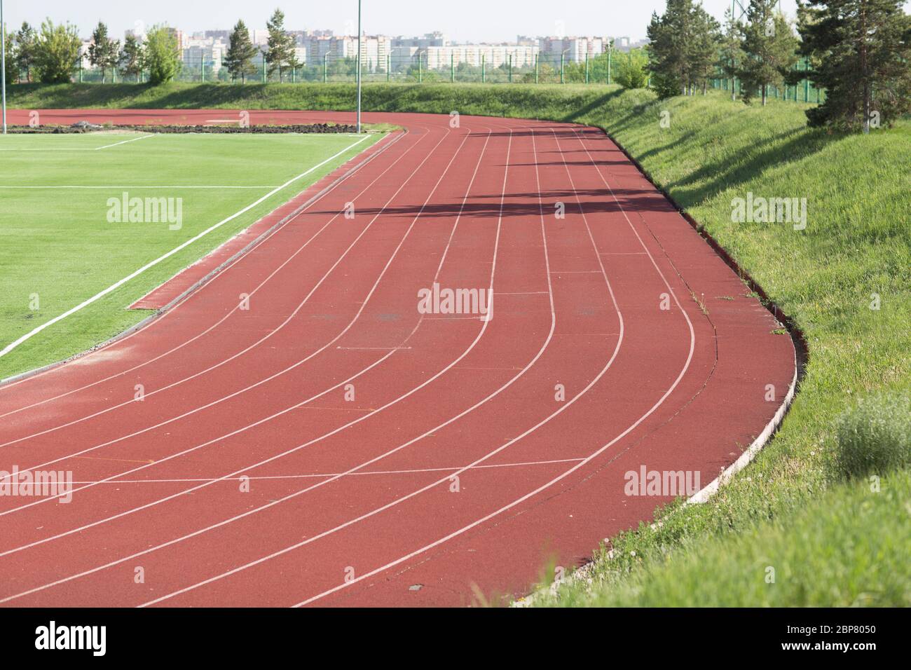 Running track and field with green grass for football at stadium Stock ...