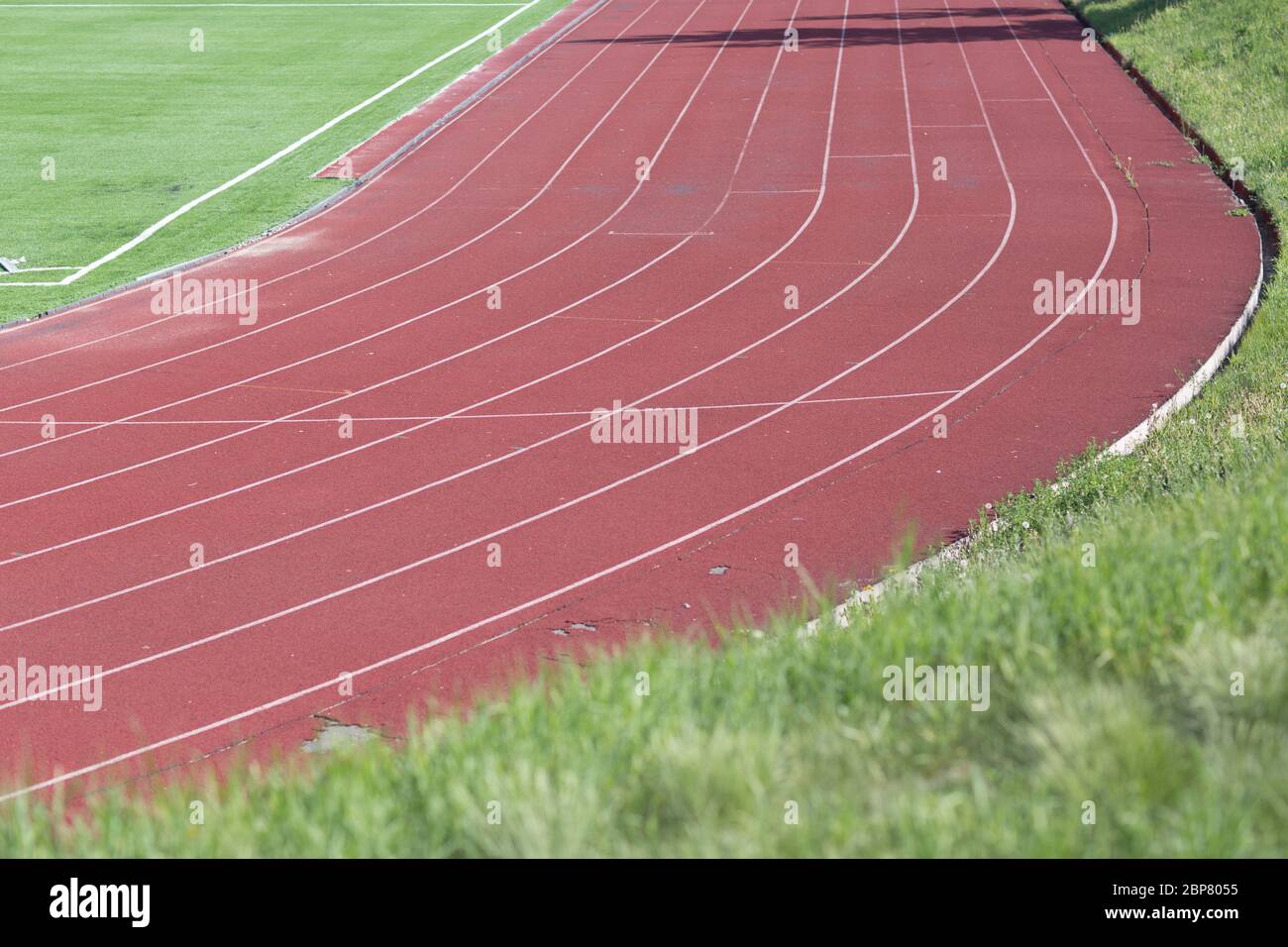 Running track and field with green grass for football at stadium Stock ...