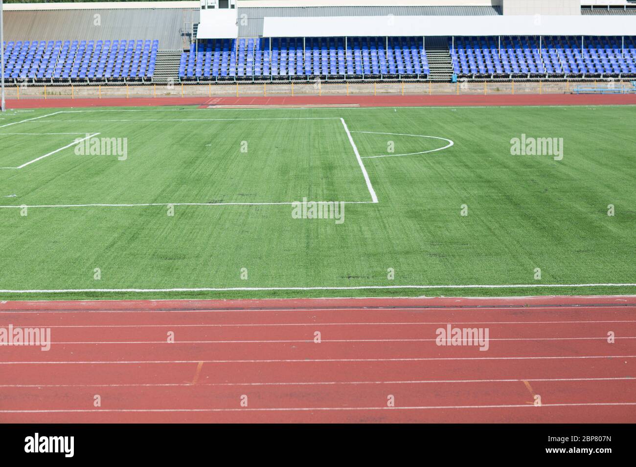 Running track and field with green grass for football at stadium Stock ...