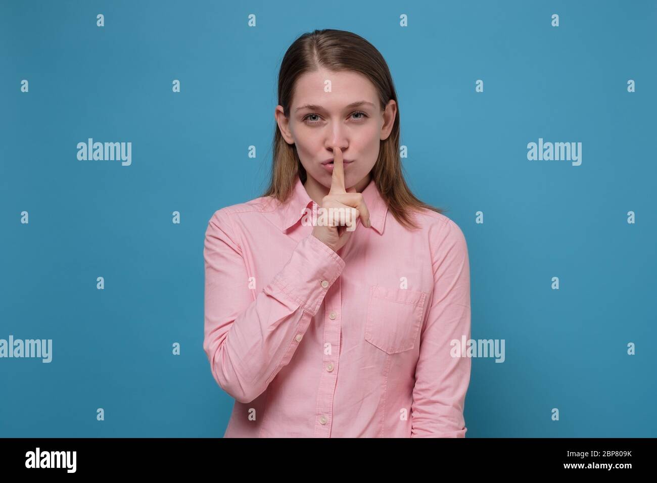 Young woman holding mouth shut hi-res stock photography and images - Alamy