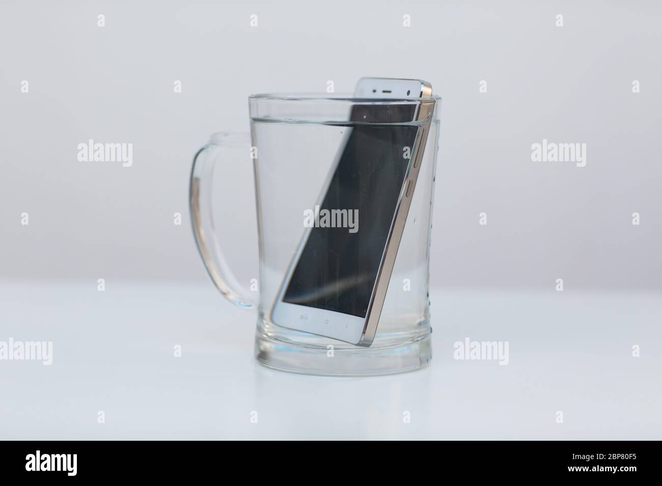 Mobile phone in vessel with water Stock Photo - Alamy