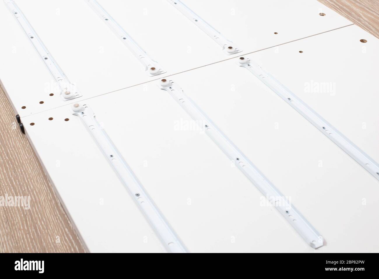 Roller guides for installation during furniture assembly, background ...