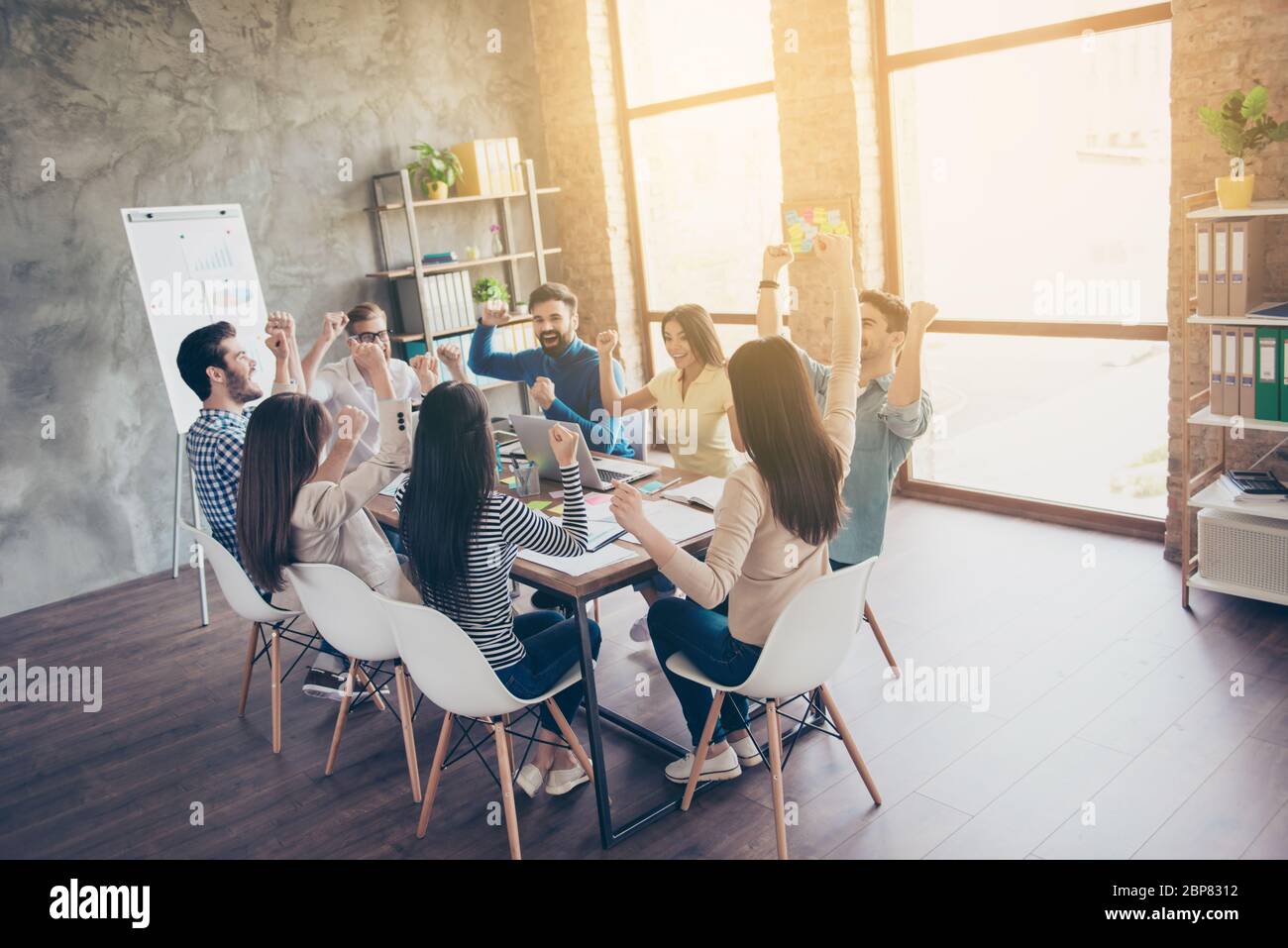 We are the champions! Successful business team with raised up hands in ...