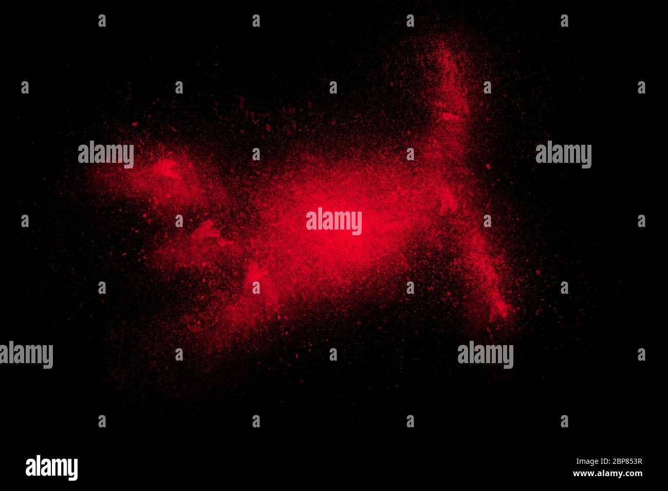 Freeze motion of red colorful powder paint exploding isolated on black ...