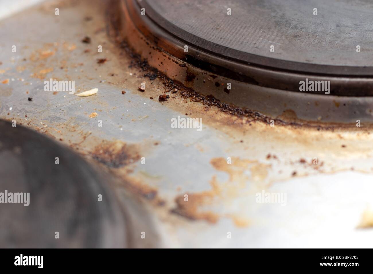 Dirty oil and residue around the stove top heaters after cooking Stock ...