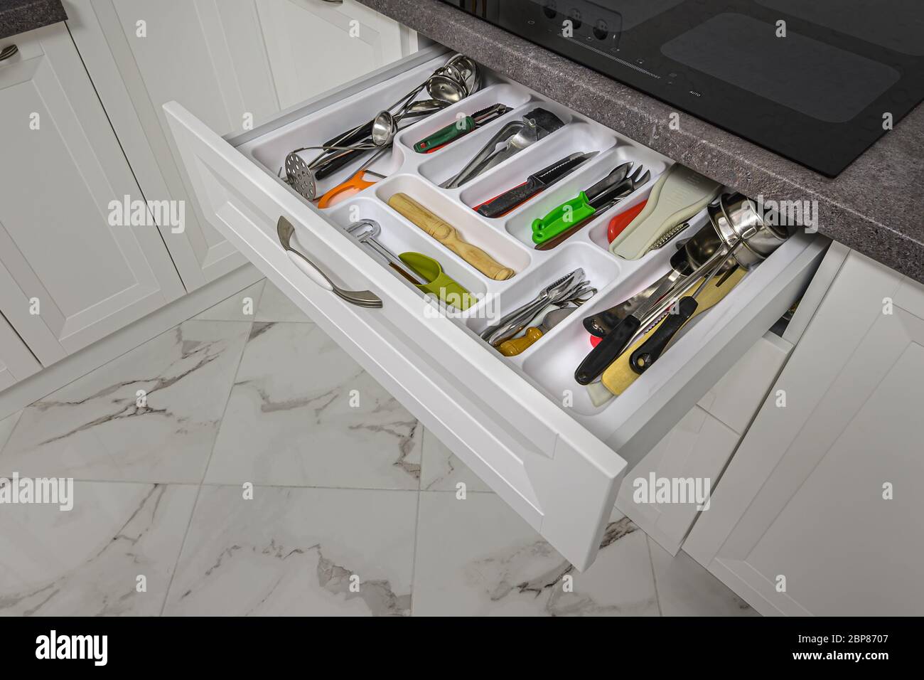 Kitchen drawer with content visible opened Stock Photo - Alamy