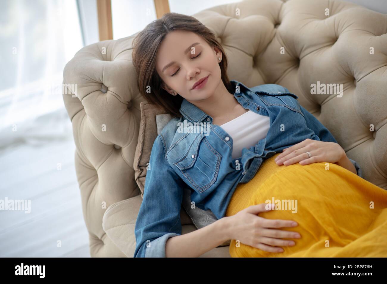 Pregnant woman in jeans hi-res stock photography and images - Alamy