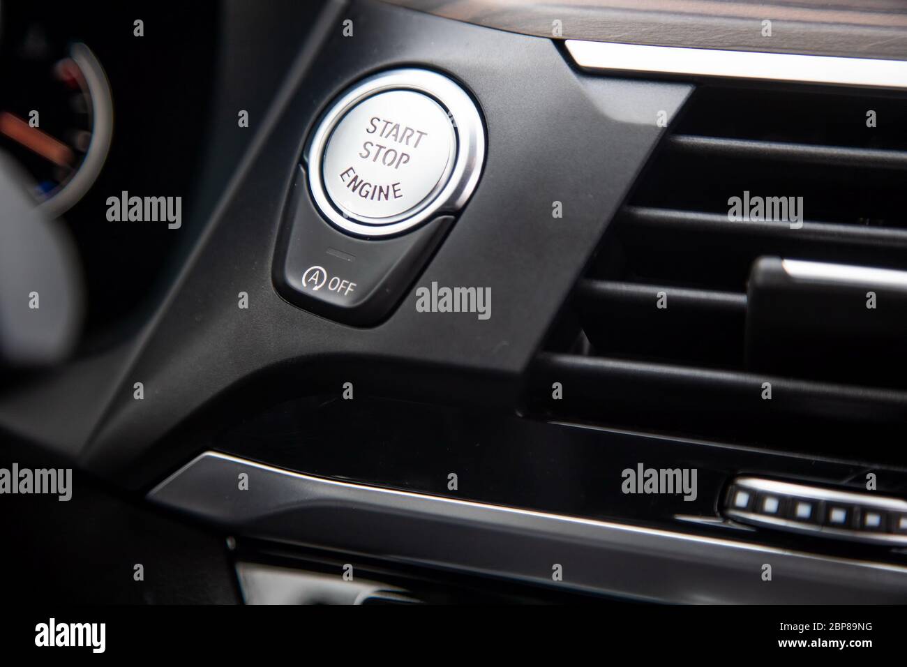 Close-up of a start-stop button on a dashboard in a modern premium ...