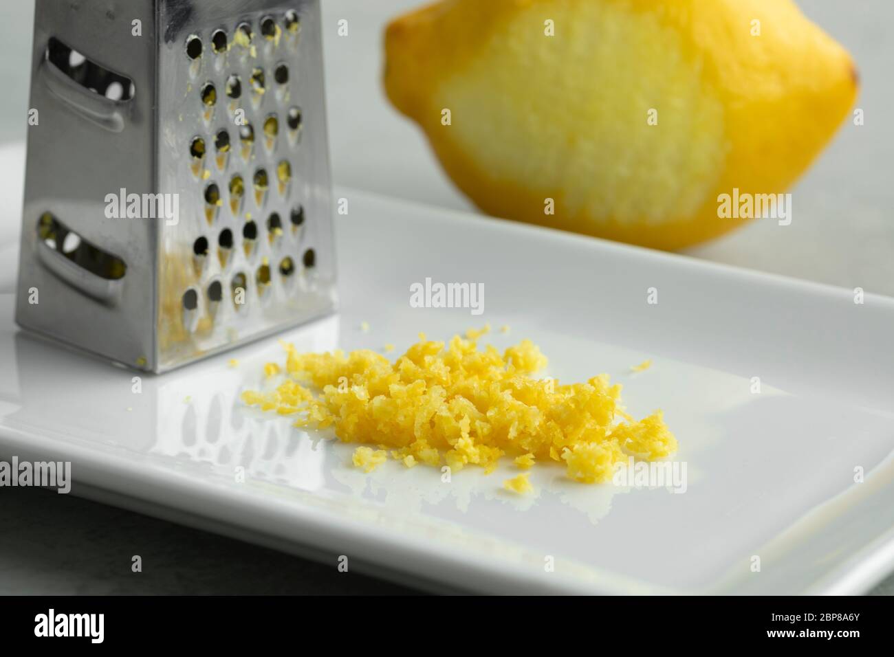 Fresh lemon zest and grater close up Stock Photo - Alamy