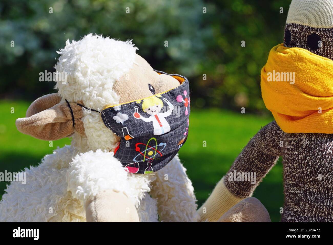 Two childrens plush stuffed animal toys earing a face mask during the ...