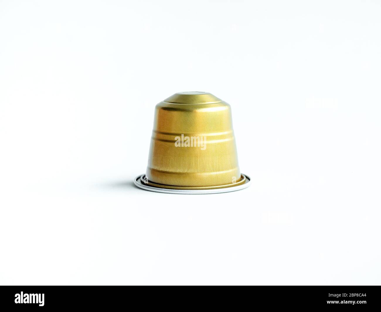 Gold espresso coffee capsule isolated on white background Stock Photo ...