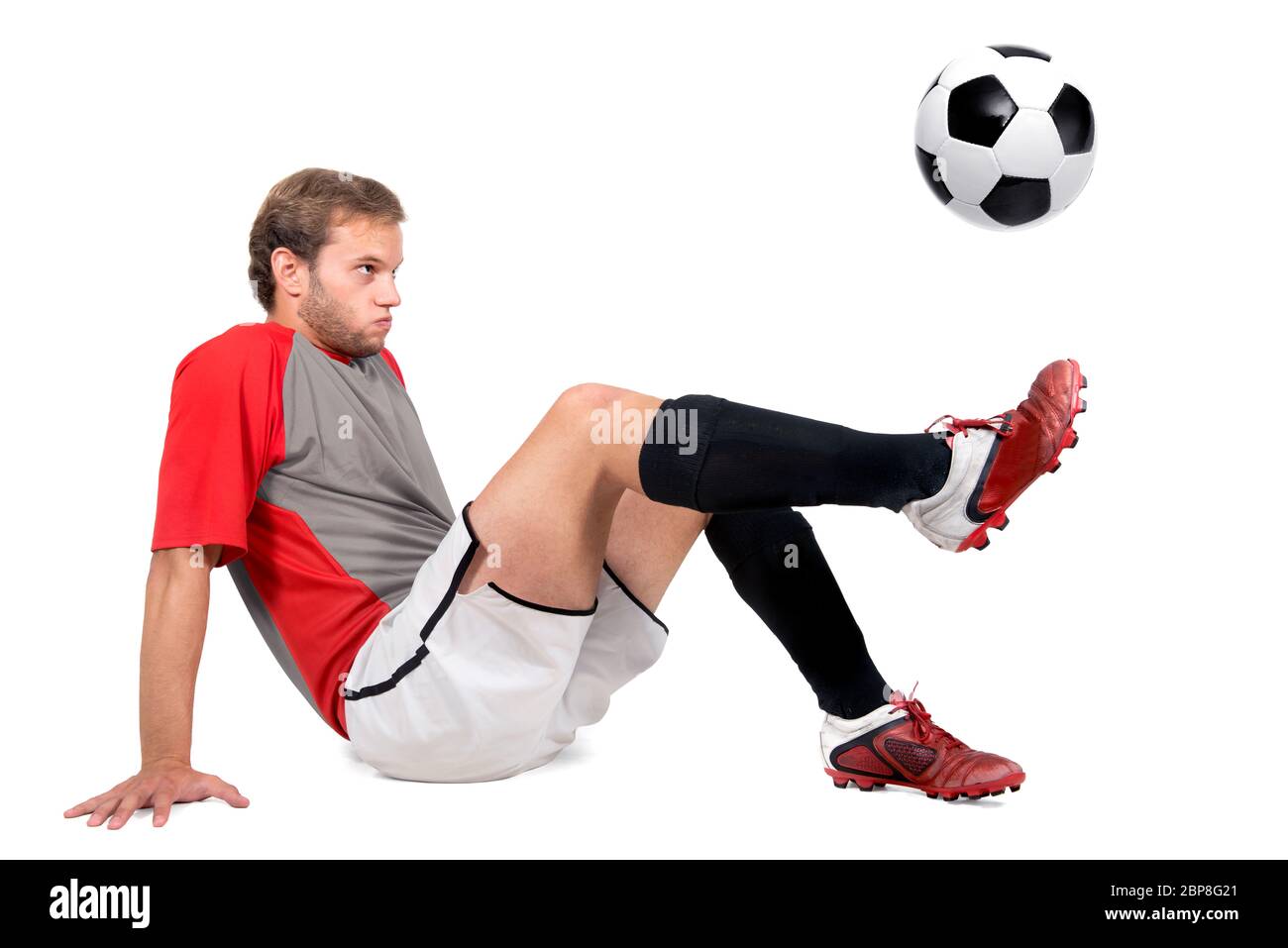 Football player with a ball isolated in white Stock Photo - Alamy