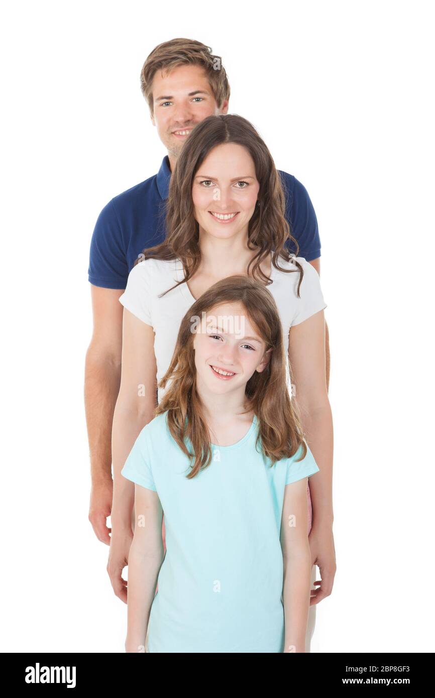 Full length portrait of family standing in line isolated over white ...