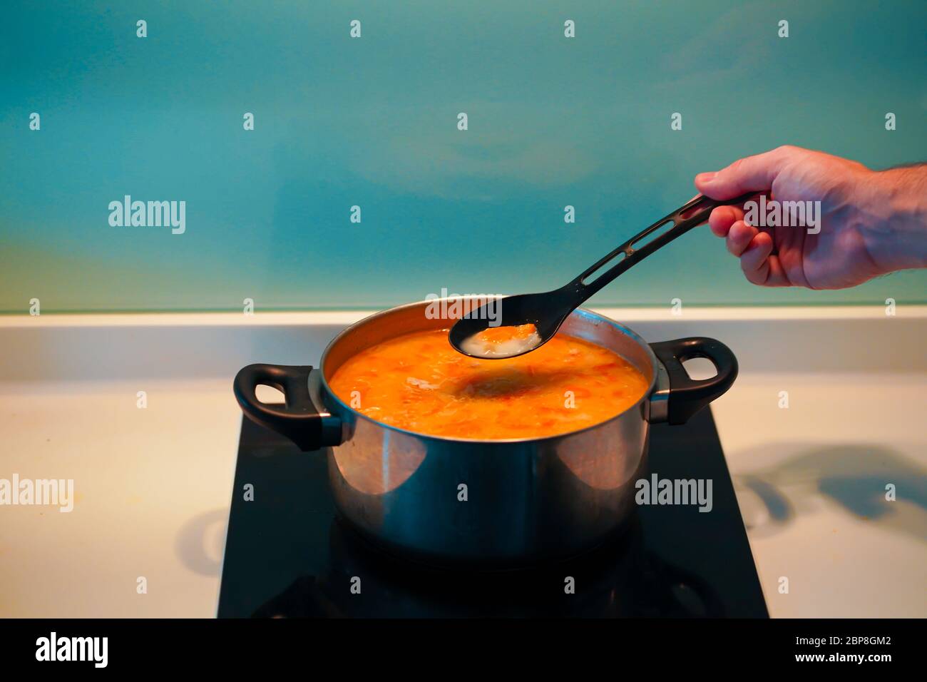 Cooking soup in a pan on an induction stove Stock Photo - Alamy