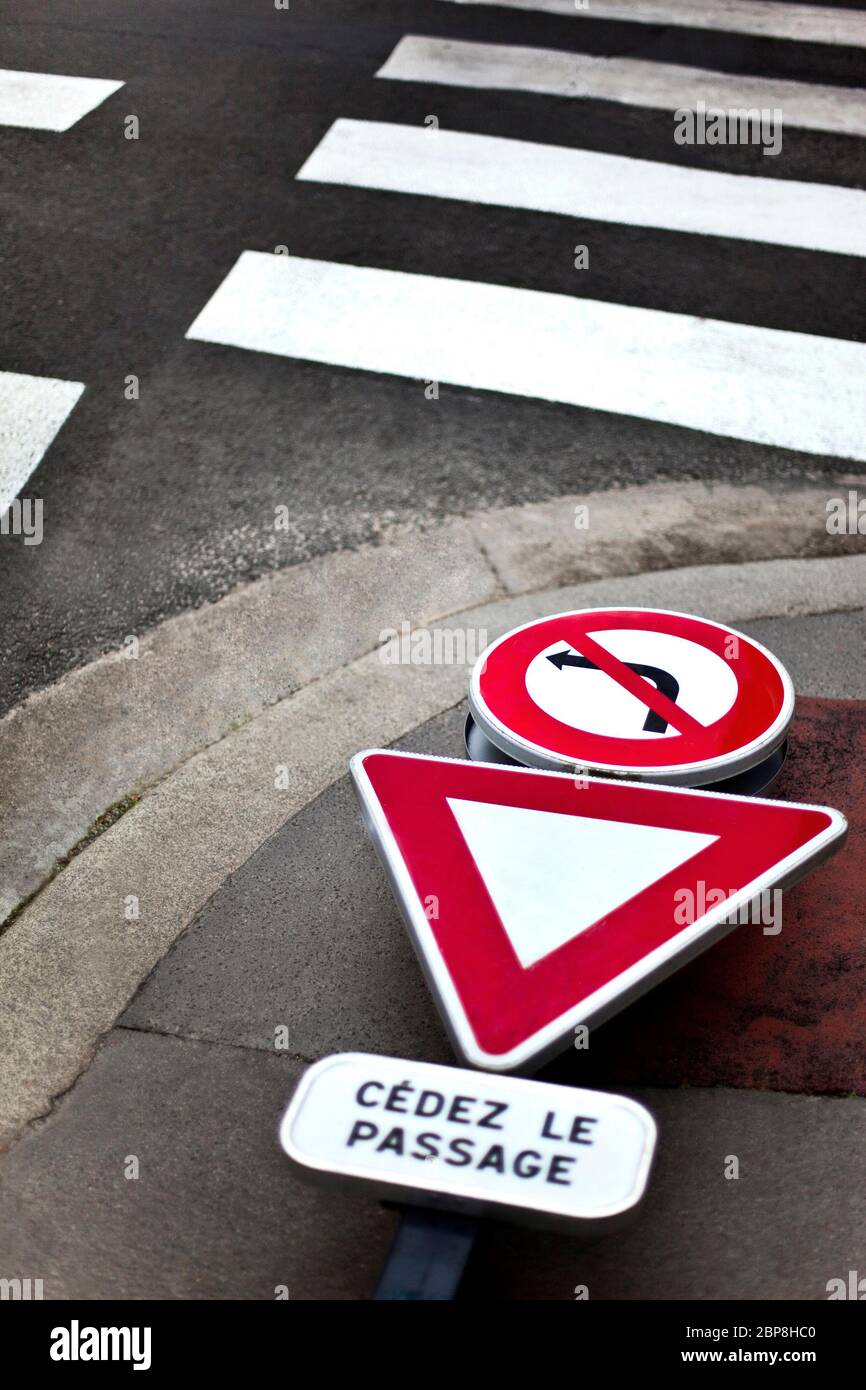 Traffic sign dropped on a sidewalk in town Stock Photo - Alamy
