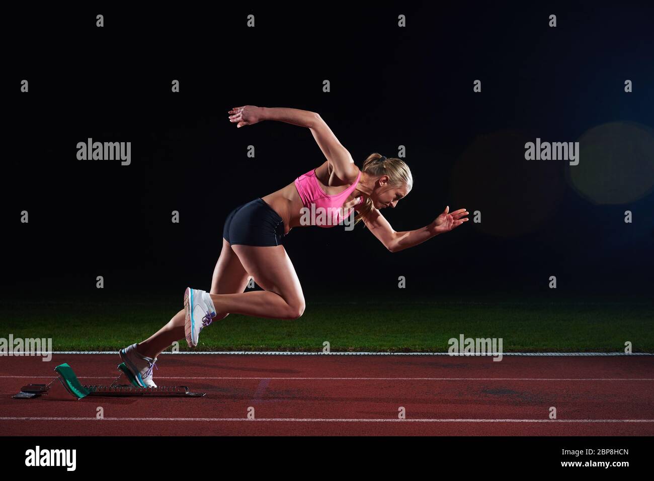 pixelated design of woman sprinter leaving starting blocks on the ...