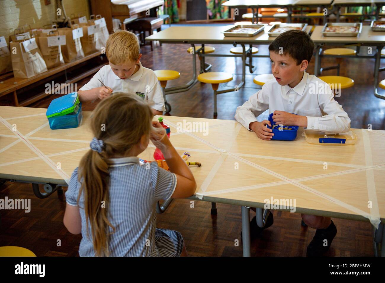 Children of essential workers eat lunch in segregated positions at ...