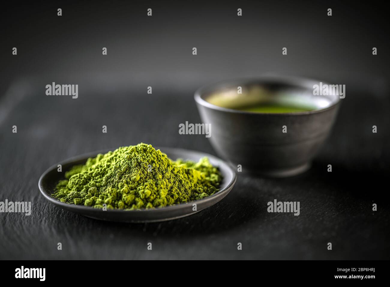 Matcha, powder green tea in black plate Stock Photo - Alamy
