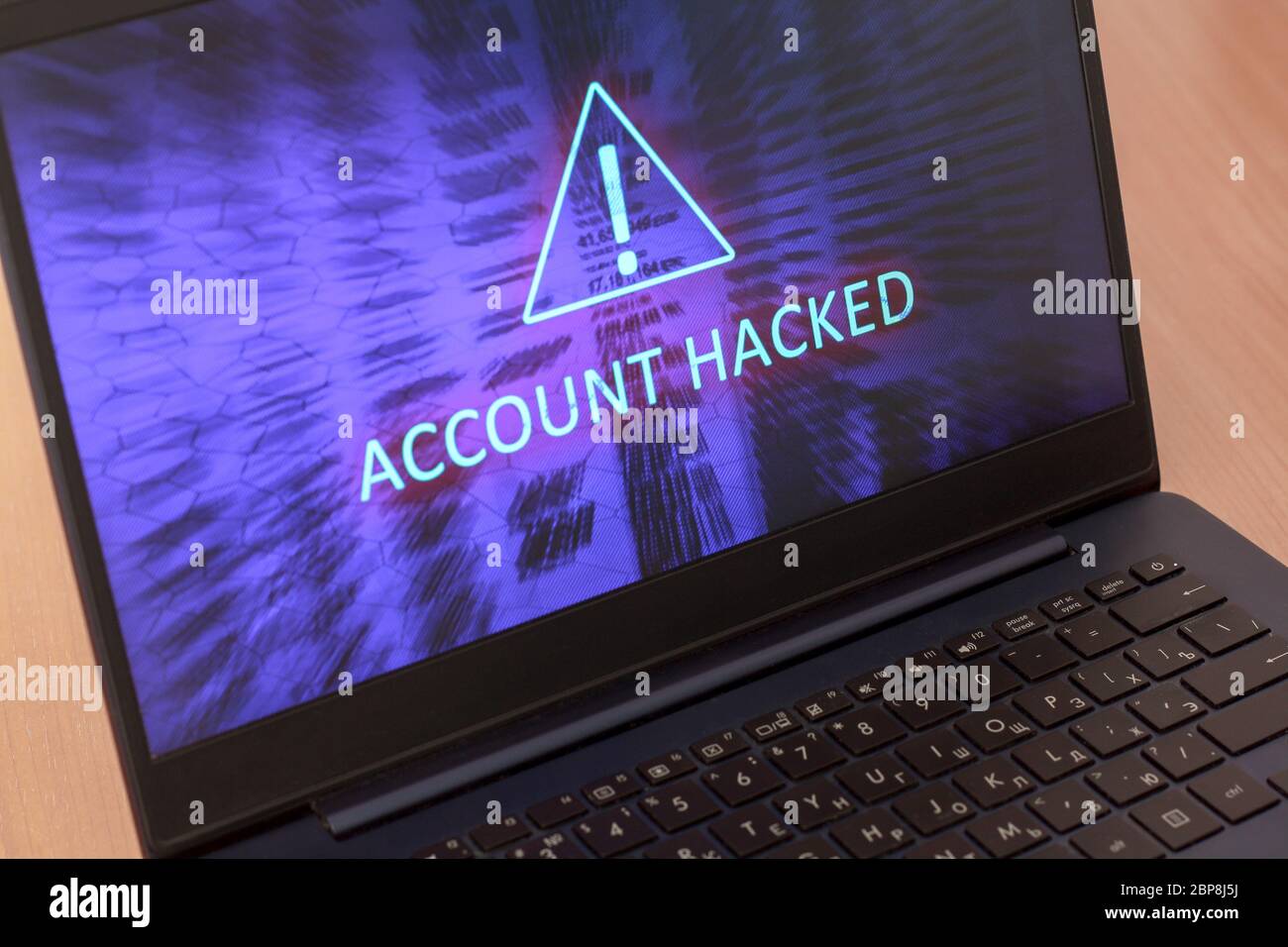 Text account hacked on laptop screen. Warning triangular sign with ...