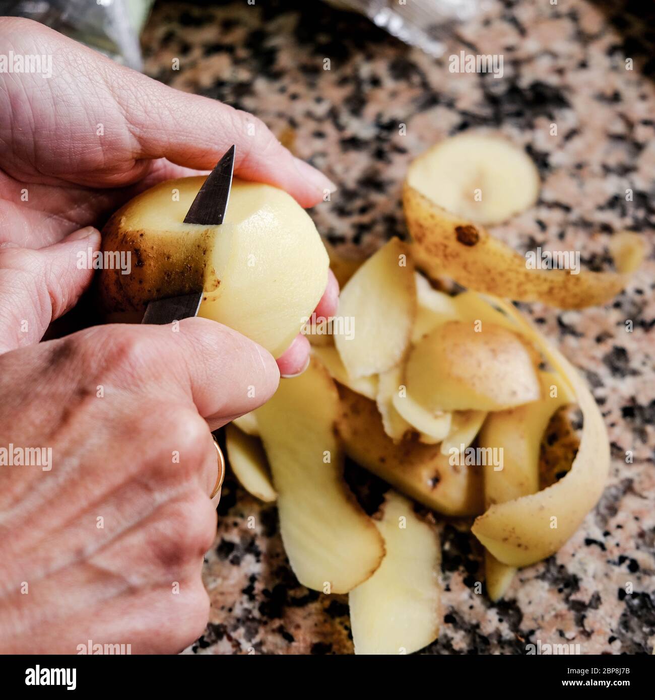 Woman peeling a potato hi-res stock photography and images - Alamy